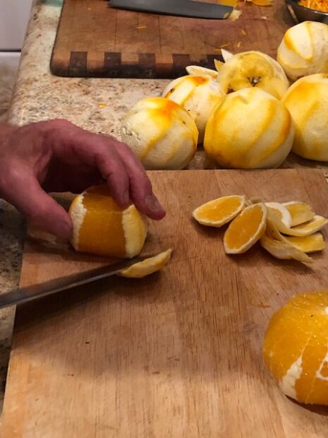 5. Hold a fully peeled orange and use a sharp knife to cut out each ...